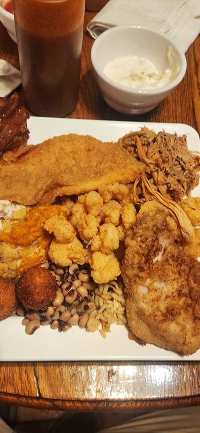 This isn't just a plate—it's a Southern symphony. The fried chicken alone would make Colonel Sanders rethink his life choices.
