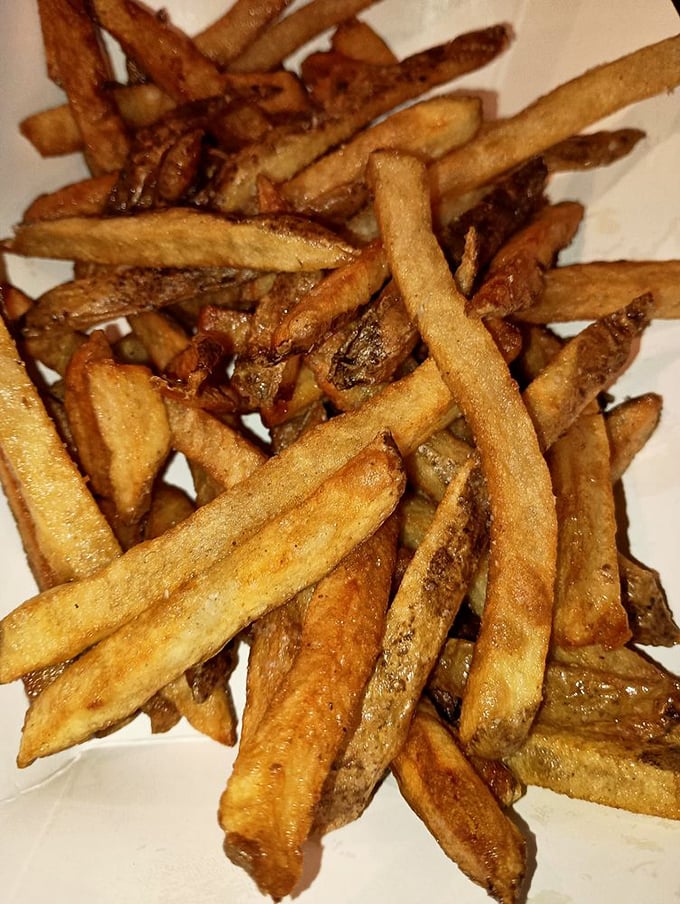 Hand-cut fries with personality—some crispy, some soft, all delicious. The kind that make you fight over the last one at the table.