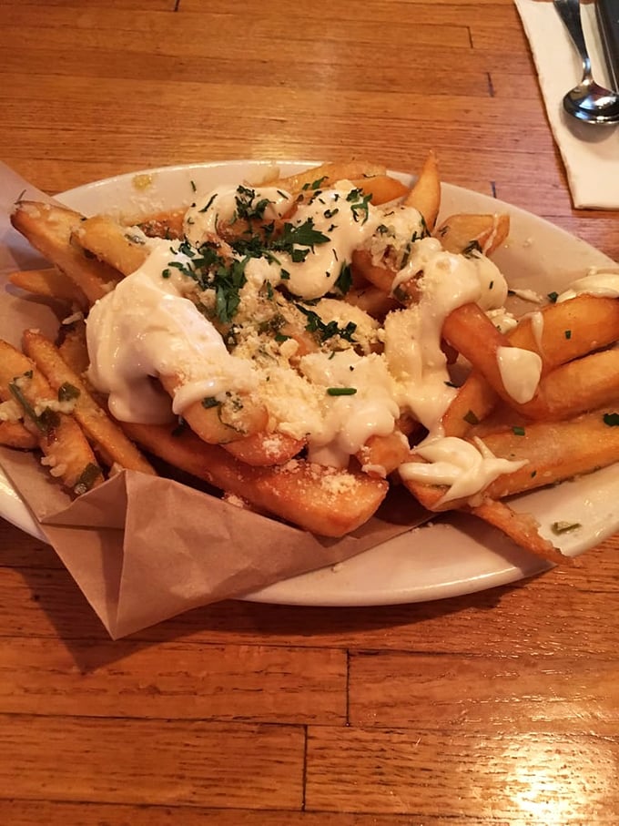 These aren't just fries—they're garlic-dusted, cheese-blessed potato vehicles for transferring joy directly to your soul.