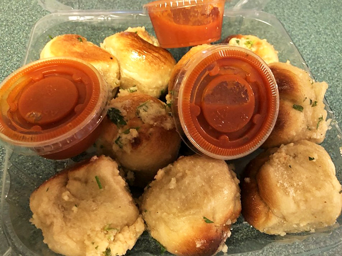 Garlic knots: the unsung heroes of Italian-American cuisine. These pillowy flavor bombs come with dipping sauce that should be bottled and sold nationwide.