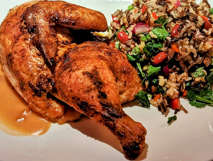 A roasted chicken that's achieved celebrity status—golden, crispy skin giving way to juicy meat, with a grain salad that's anything but an afterthought.
