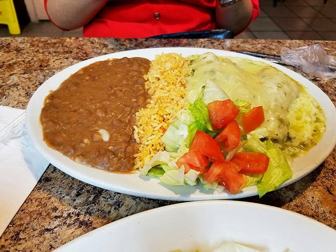 These green enchiladas aren't just covered in sauce—they're swimming in a verdant pool that makes you wonder why anyone would choose red sauce ever again.