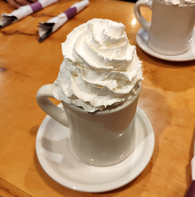 Hot chocolate that's more whipped cream than beverage – exactly as it should be. Winter comfort in a mug, no matter the season.