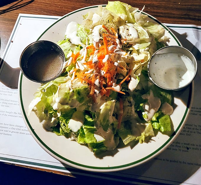 Even the house salad gets the royal treatment. Those two dressing cups aren't suggestions—they're an invitation to customize perfection.