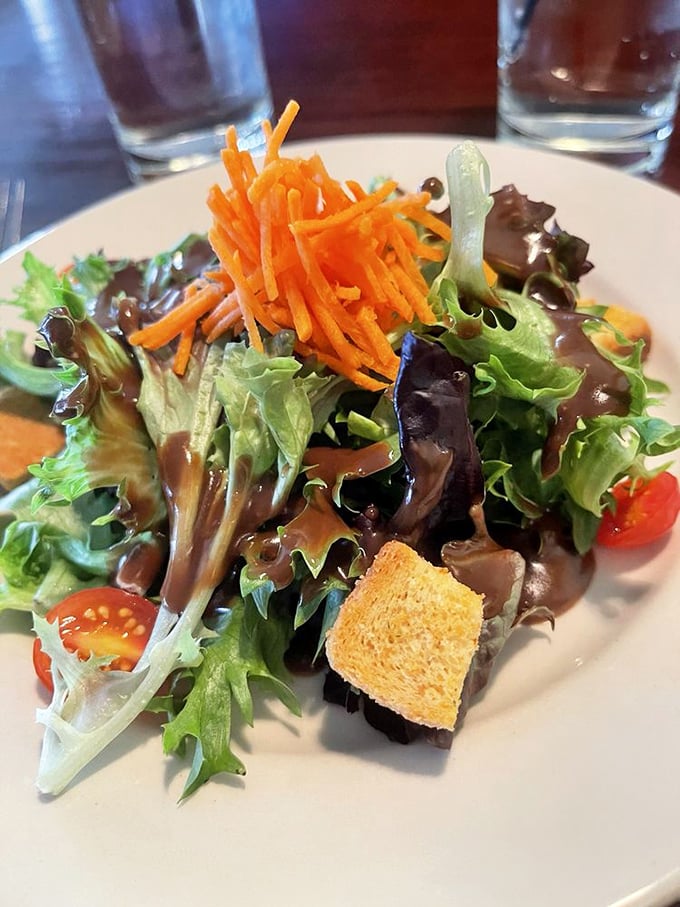 Even the house salad gets the star treatment – fresh greens, vibrant carrots, and a crouton that didn't come from a box.