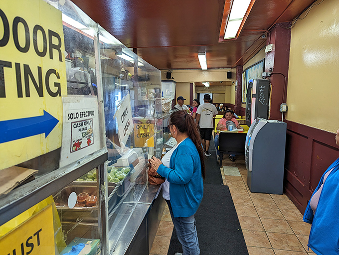 The narrow corridor to burrito heaven—where patience is rewarded and indecision at the counter is punishable by stern looks.