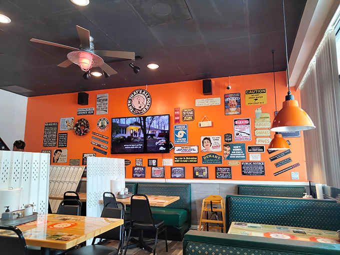 Interior Another Angle: The orange accent wall serves as both design choice and mood enhancer—covered in enough witty signs to keep you entertained between coffee refills.