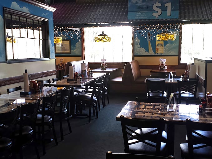 The dining room balances family-friendly comfort with maritime charm—string lights overhead creating the perfect atmosphere for seafood feasting.
