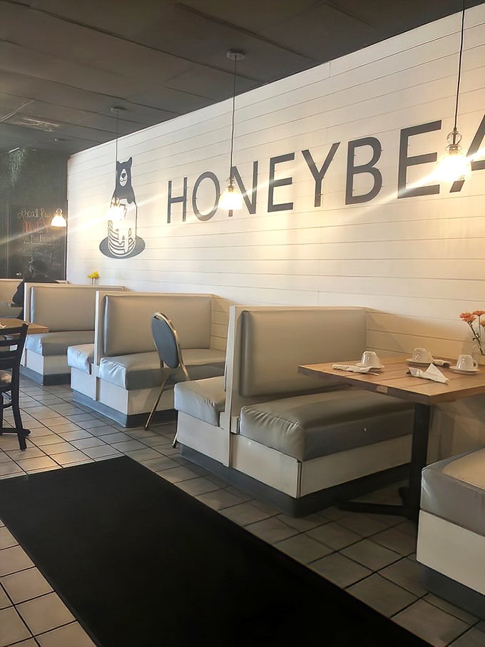 The signature Honeybear logo watches over diners from its perch on shiplap walls—a pancake-loving bear that perfectly captures this restaurant's playful spirit.