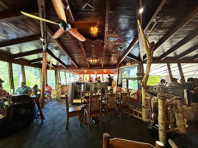 Tree trunks stand sentinel inside the dining room, as if nature herself refused to leave when they built this woodland sanctuary.