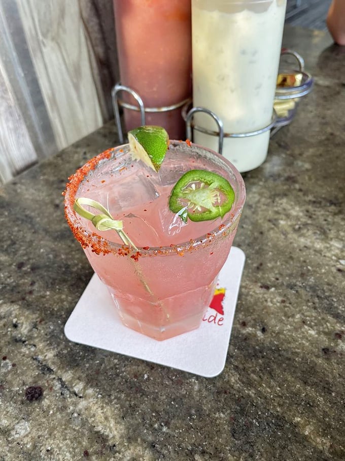 A spicy watermelon margarita with jalapeño slices – where sweet, heat, and tequila meet for Florida's perfect sunset companion.