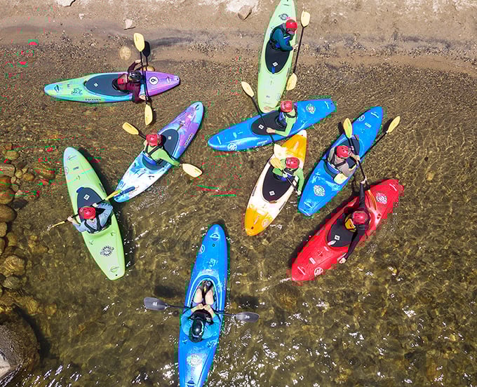 Colorful kayaks gather like a floating rainbow—a refreshing sight when you live in a town where "waterfront property" usually means "next to the sprinkler."