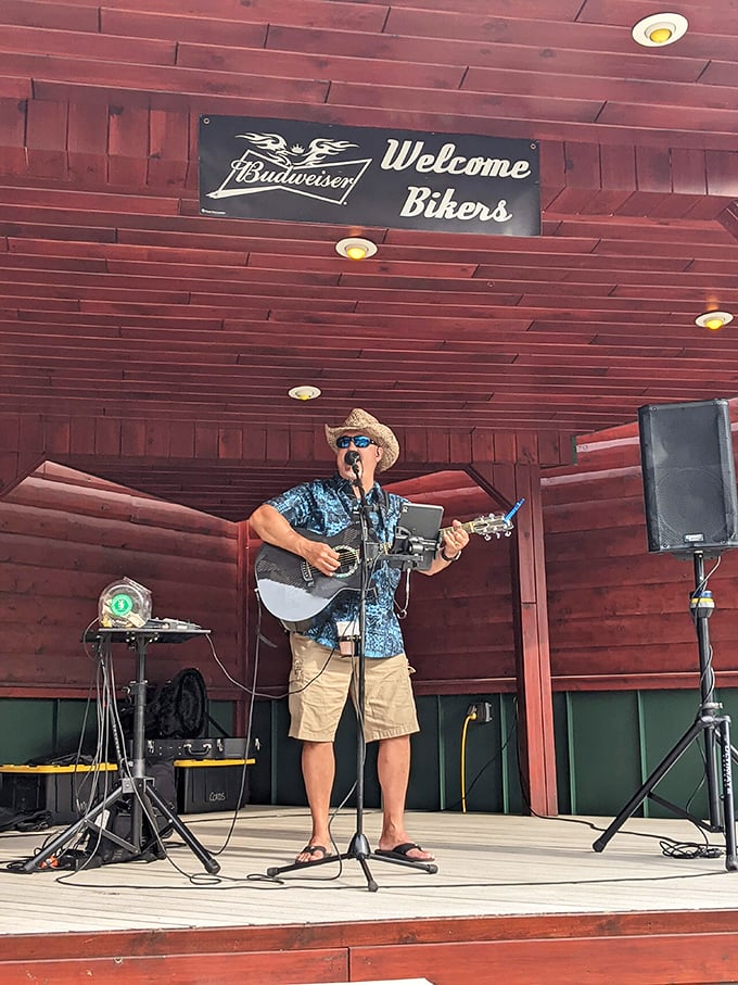 Live music under wooden beams—because nothing pairs with BBQ quite like acoustic tunes and a "Welcome Bikers" sign.