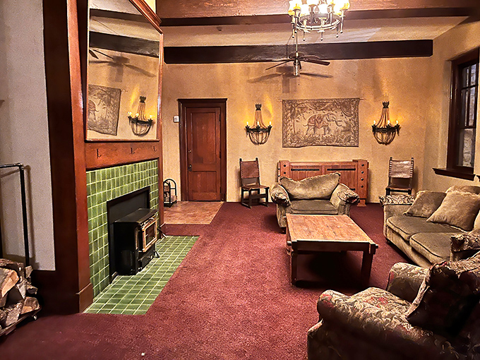 This cozy sitting room with its green-tiled fireplace feels like the perfect spot to plot a mystery or simply enjoy a quiet moment. 