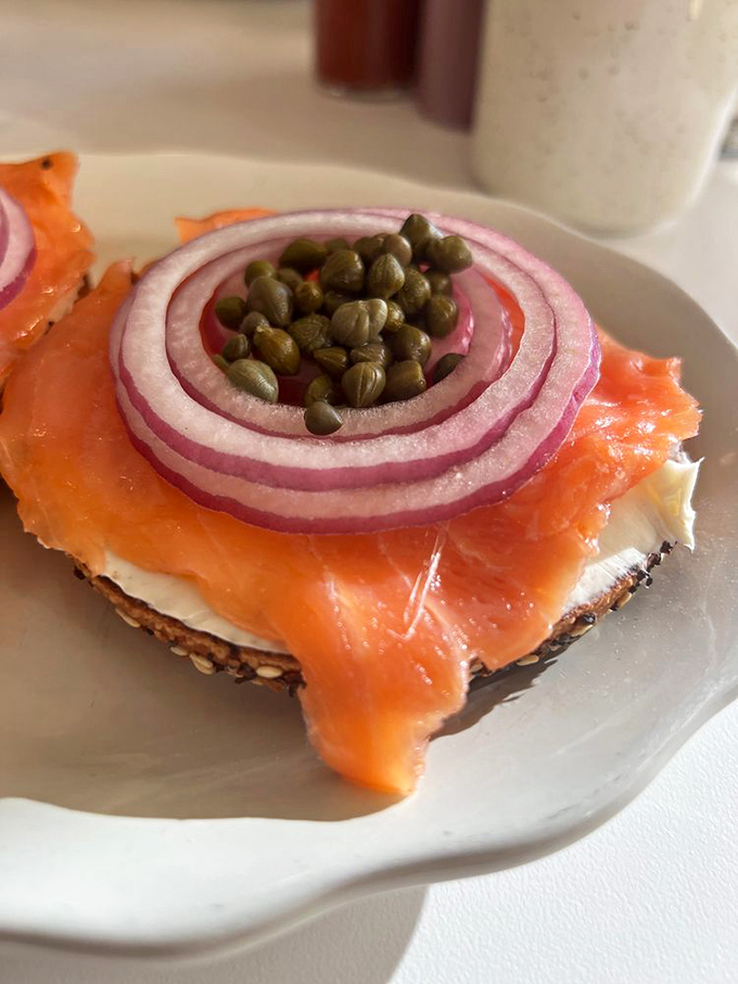 The classic lox setup – where salmon, cream cheese, capers, and onion perform a synchronized swimming routine of flavor.