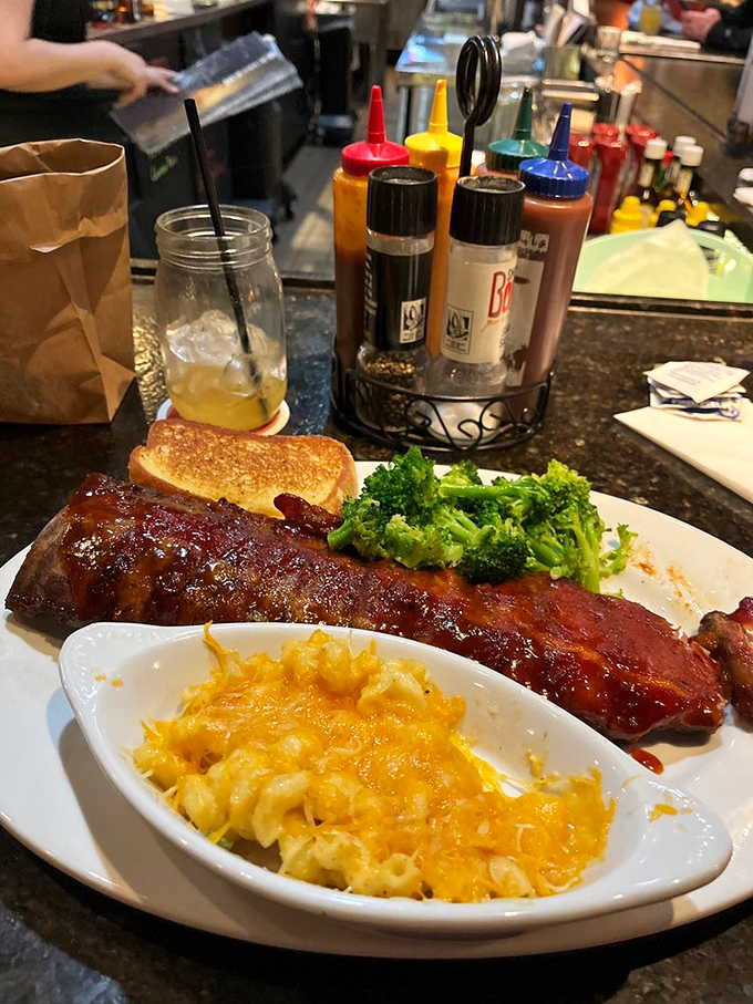 A rack of ribs lounging beside mac and cheese that's achieved that perfect orange hue—the color that signals comfort is imminent.