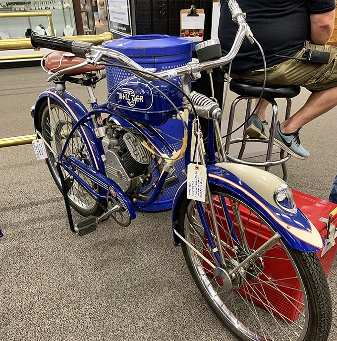 This gleaming blue Whizzer motorcycle isn't just transportation—it's a time machine on two wheels, ready to zoom back to simpler days.