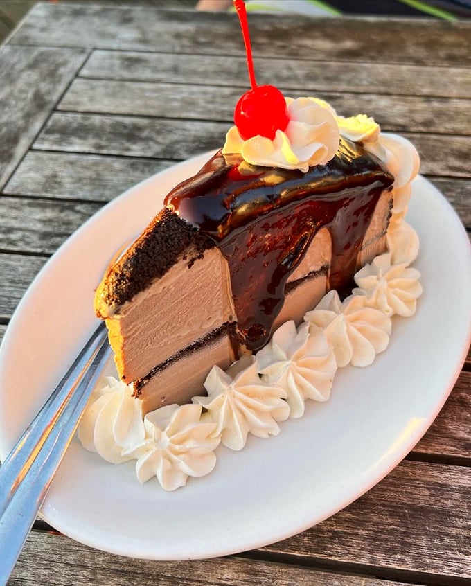A slice of mud pie that doesn't just end your meal—it provides closure with chocolate therapy and whipped cream comfort.