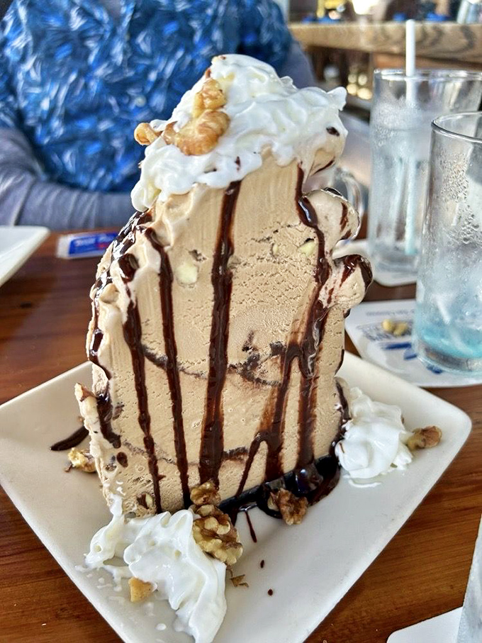 A mud pie that defies gravity and good sense. This towering dessert isn't just a sweet ending—it's a chocolate-drizzled monument to indulgence.