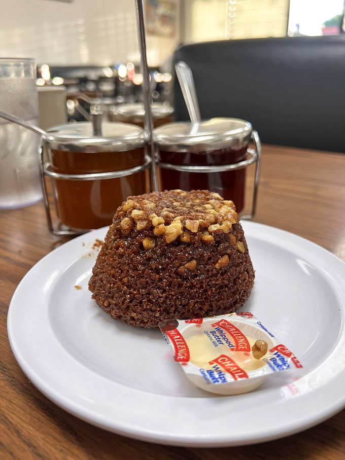 This walnut-topped muffin isn't just dessert masquerading as breakfast—it's your reward for making it through the door before the morning rush.