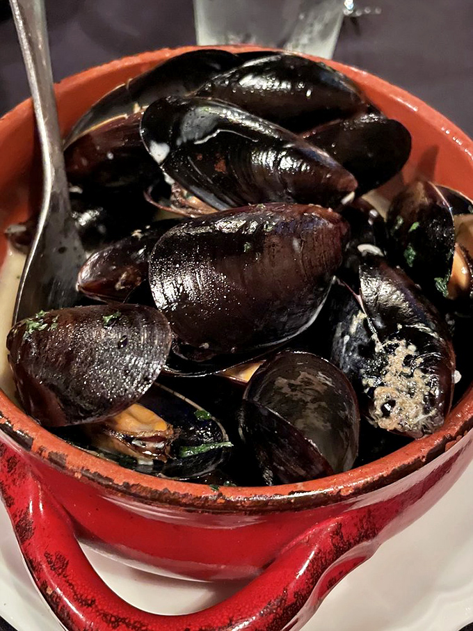 These mussels aren't just swimming in sauce—they're performing synchronized flavor diving in a pool of garlicky goodness.