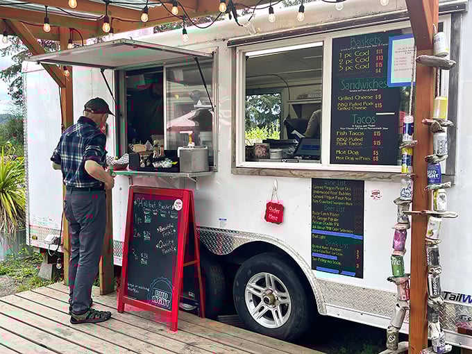 The food truck window—where culinary magic happens with minimal fuss and maximum flavor, proving great seafood needs no marble countertops.