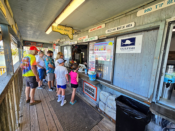 The order window – where dreams come true and diets go to die. Notice how nobody's checking their phone while waiting for their number to be called.