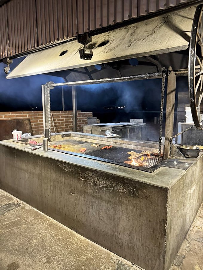 The beating heart of Li'l Abner's – an outdoor pit where smoke, fire, and skill transform good meat into something that haunts your dreams.