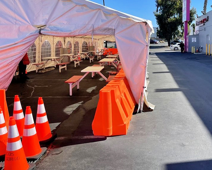 Even outdoor dining gets the royal treatment with proper seating under protective tent coverage.