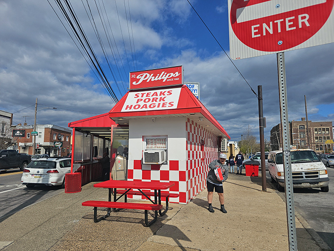 The red and white checkerboard exterior isn't trying to be Instagram-worthy—it just naturally is. Outdoor seating for sandwich contemplation.