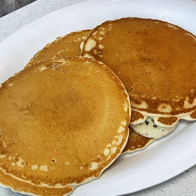 Pancakes with the perfect golden hue, their edges lacy with promise. The kind that make you wonder why anyone bothers with fancy breakfast.