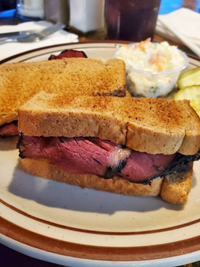 A pastrami sandwich that doesn't mess around—thick-cut meat, perfectly toasted bread, and a pickle standing guard on the side.