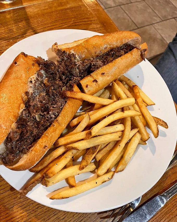 The Philly cheesesteak alongside perfectly golden fries. Not just a sandwich but a regional handshake—a proper introduction to Pennsylvania's flavor personality.