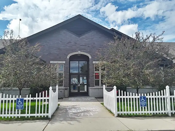 Behind that white picket fence lies a library where books still matter and the WiFi password isn't the main attraction.