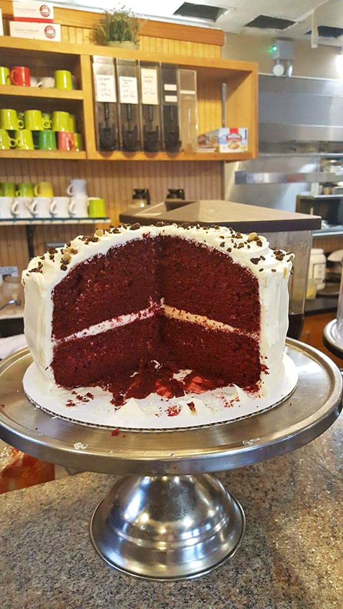 Red velvet cake so moist it should require a warning sign. That cream cheese frosting layer is the sweet equivalent of finding an extra $20 in your pocket.