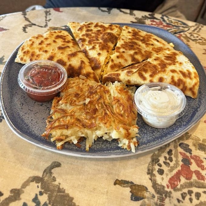 Quesadilla meets breakfast in a crispy, cheesy handshake. Those hash browns deserve their own fan club.