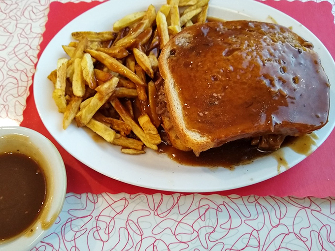 Gravy isn't just a topping here—it's a philosophical statement, creating a savory lagoon where your hot roast beef sandwich becomes an island paradise.