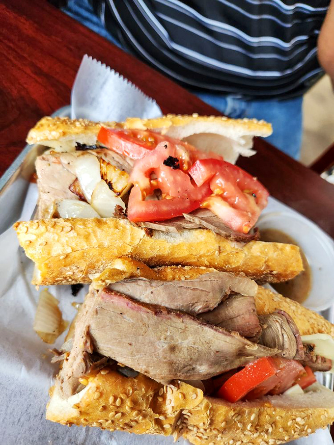 The roast beef sandwich – where thinly sliced meat, fresh tomatoes, and a sesame-seeded roll create a trifecta of lunchtime perfection.