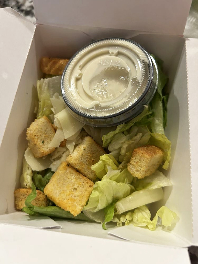Even salads get the royal treatment here. Crisp lettuce, crunchy croutons, and dressing on the side—a nod to those of us pretending to be virtuous.