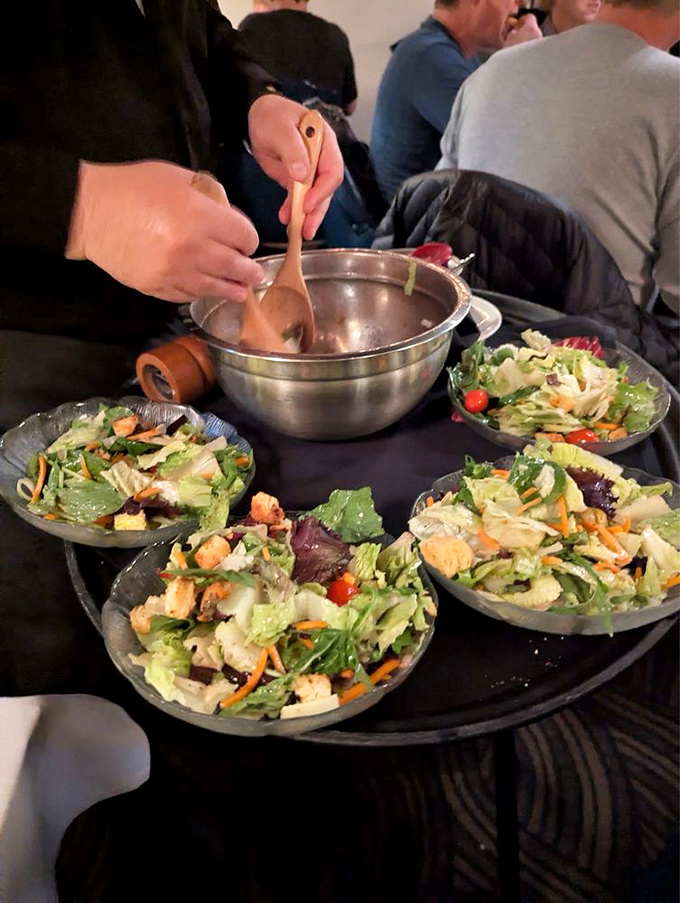 The tableside salad service – where ordinary lettuce gets dressed up for a night on the town with croutons playing the role of delicious confetti.