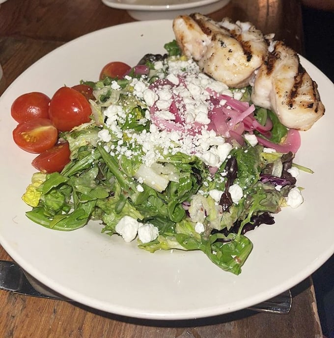 A salad that actually excites—fresh greens playing host to grilled shrimp, feta, and vegetables that clearly weren't trucked in from another time zone.