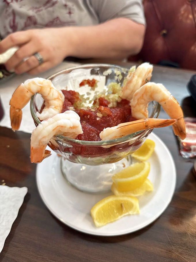 Plump shrimp perched proudly around a zesty cocktail sauce – like synchronized swimmers showing off around a spicy pool.