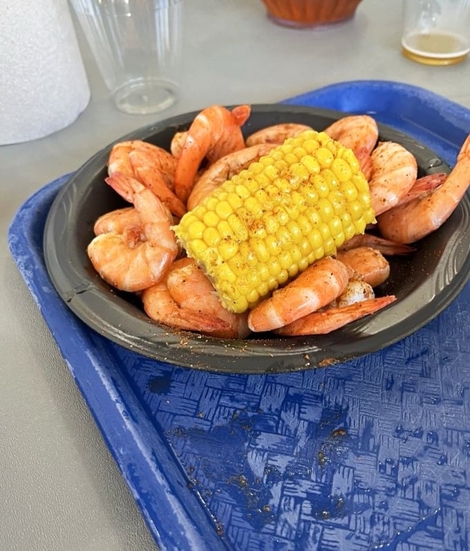 Steamed shrimp surrounding corn on the cob – a plate that says "vacation" more clearly than your out-of-office email ever could.