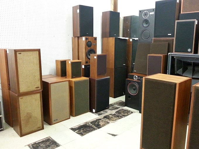 A forest of vintage speakers stands at attention. These wooden warriors once delivered Hendrix solos and Beatles harmonies into America's living rooms.