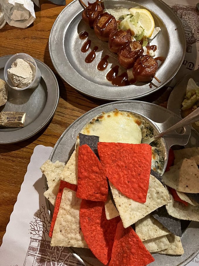 Spinach artichoke dip with tri-color tortilla chips—the kind of appetizer that ruins friendships when someone takes the last scoop.
