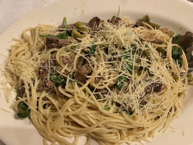 Pasta that doesn't just sit on the plate but seems to dance with tender steak pieces and vibrant greens. Comfort food with a college education.
