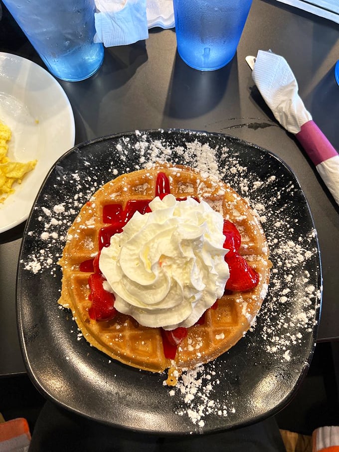 A strawberry waffle that makes you wonder why fruit salad even exists. That whipped cream mountain isn't excessive—it's necessary emotional support.