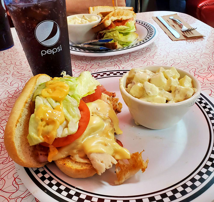 Breakfast engineering at its finest—cheese sauce, crispy potatoes, and eggs create a morning masterpiece that requires both a fork and a nap afterward.