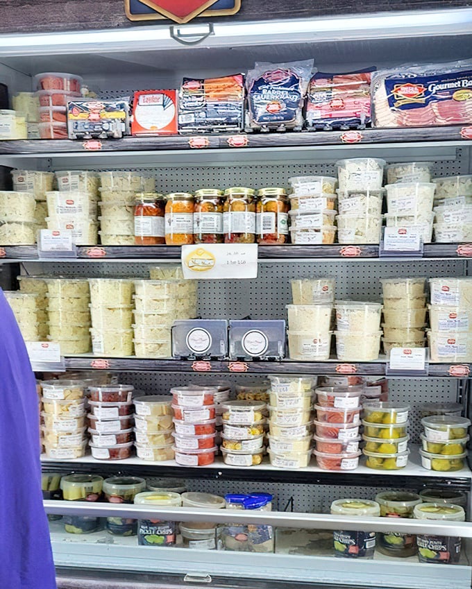 A refrigerated case packed with prepared salads and sides, offering the perfect supporting cast for your sandwich headliner.