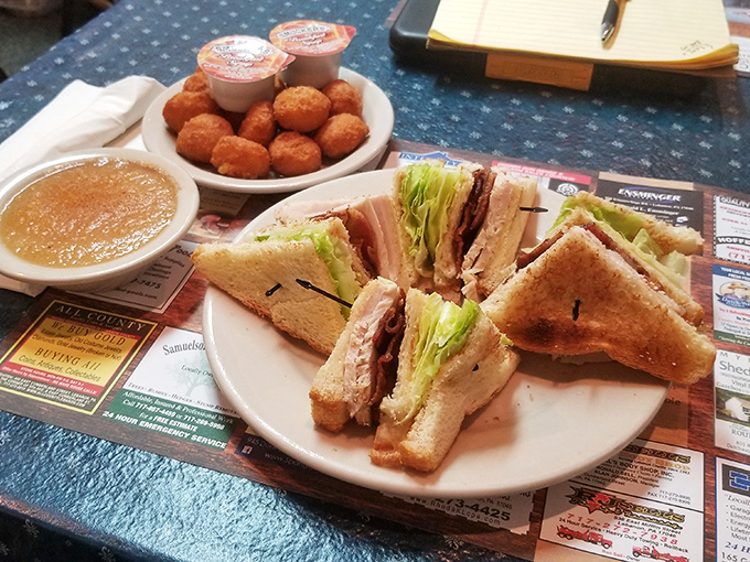 The club sandwich—architecture you can eat. Perfectly stacked layers of turkey, bacon, and veggies between toast triangles that mean business.